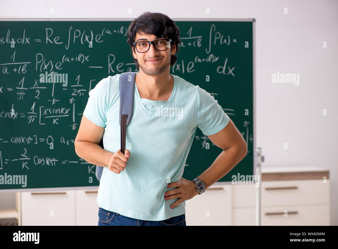 Young male student mathematician in front of chalkboard Stock Photo - Alamy