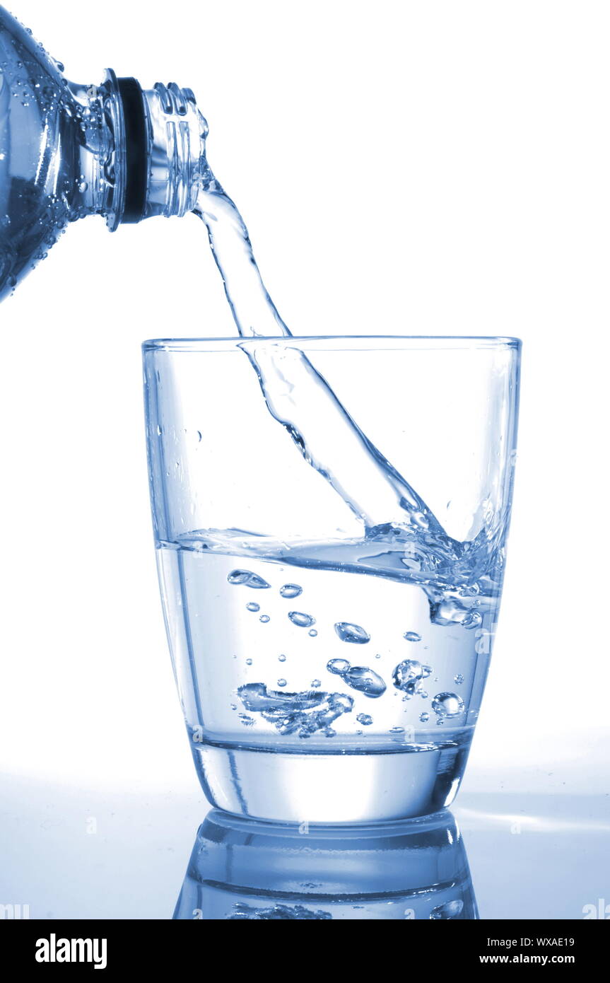 photo of pouring water and glass on white background Stock Photo - Alamy