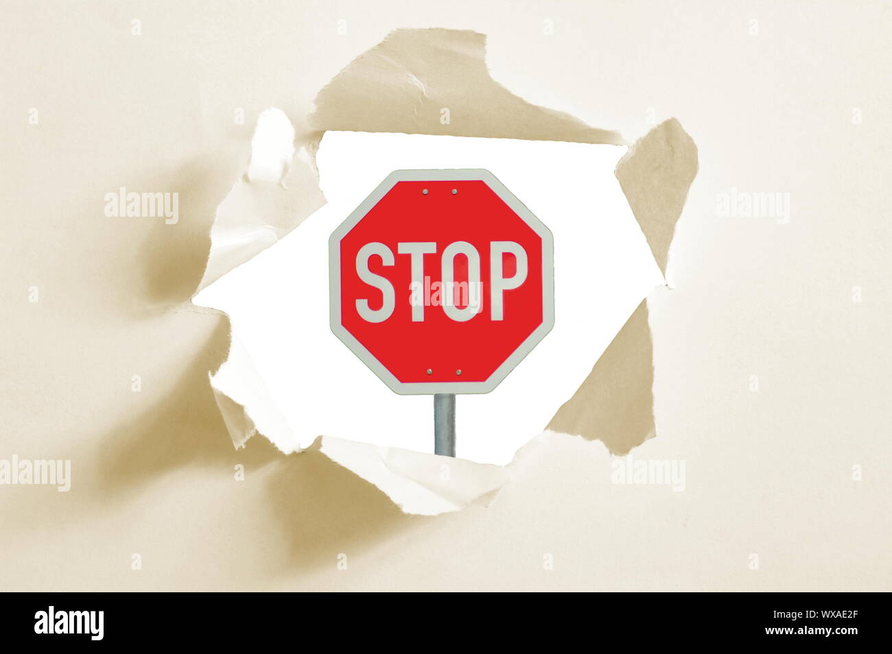 isolated stop sign in a paper hole Stock Photo - Alamy