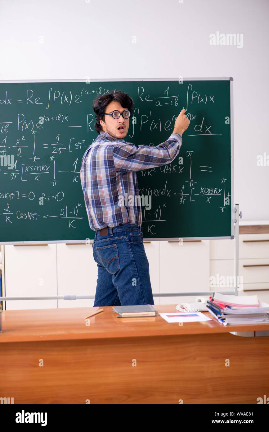 Funny male math teacher in the classroom Stock Photo - Alamy