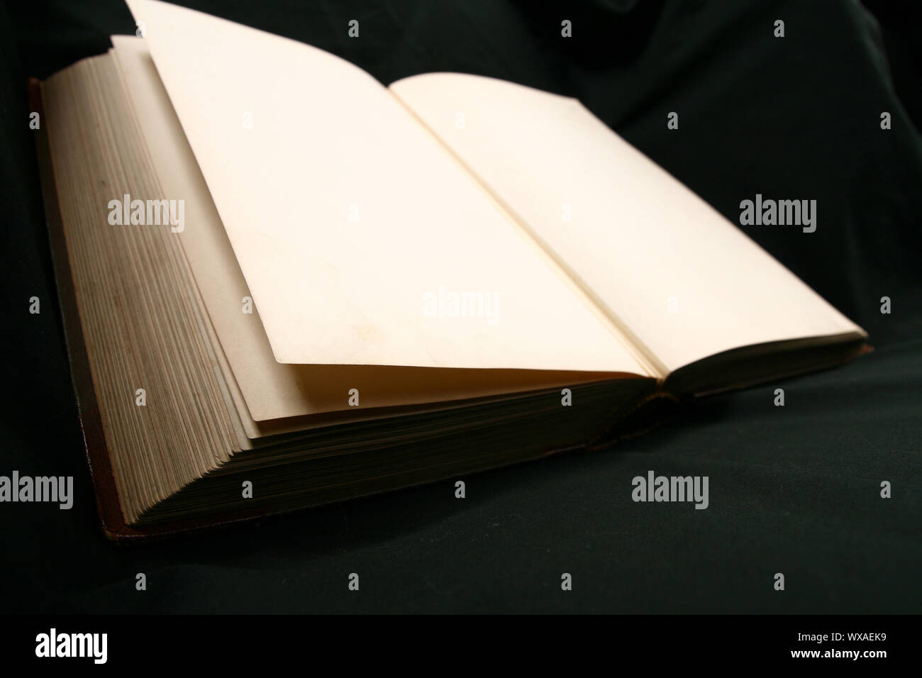 open rare old book on black fabric very Antique Stock Photo - Alamy