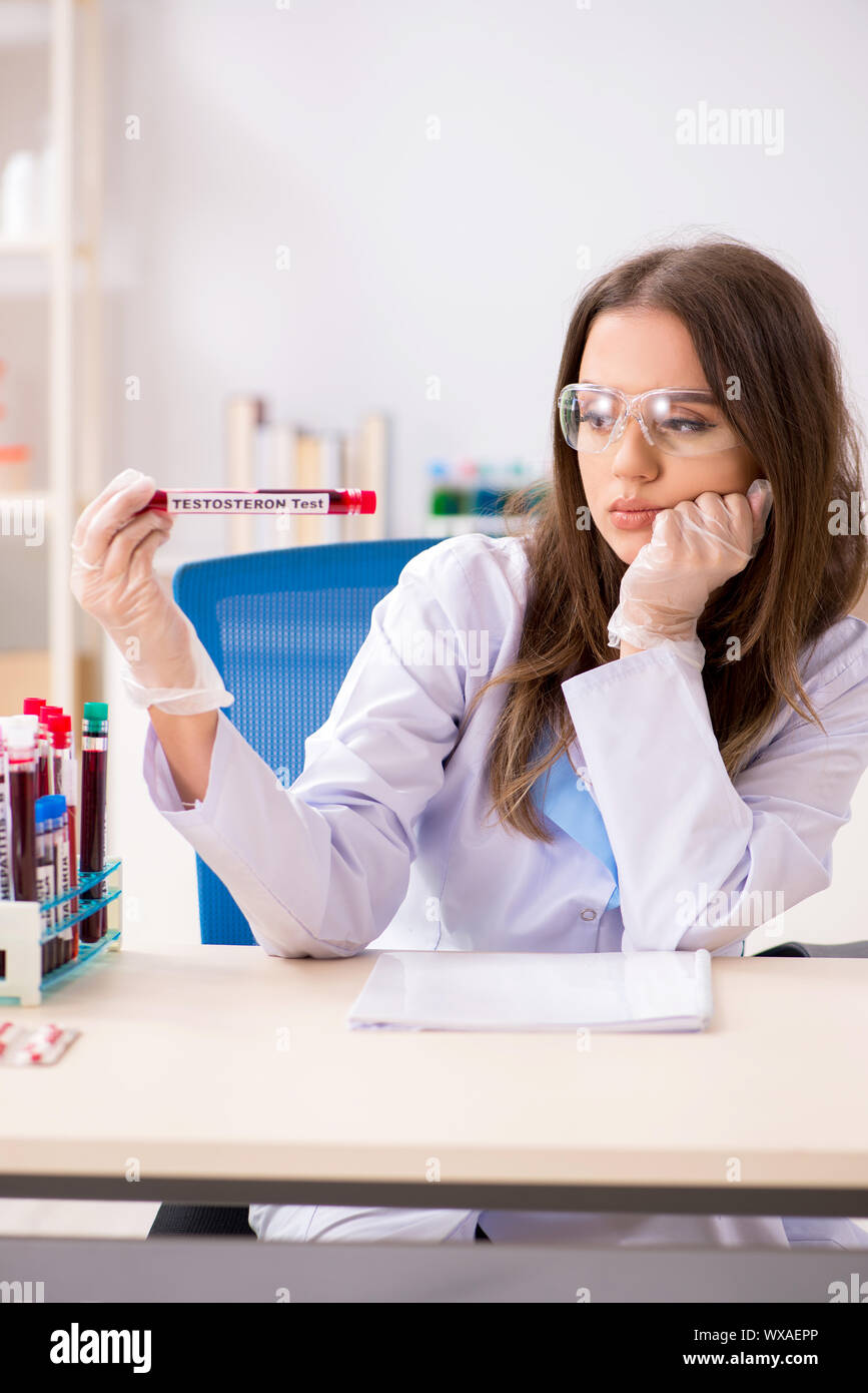 Young beautiful lab assistant testing blood samples Stock Photo - Alamy