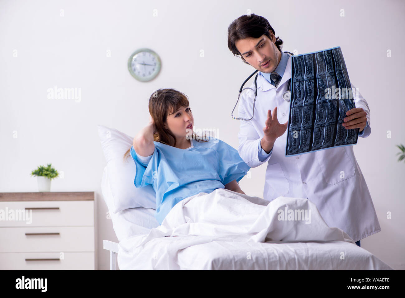 Male doctor visiting female patient in ward Stock Photo - Alamy