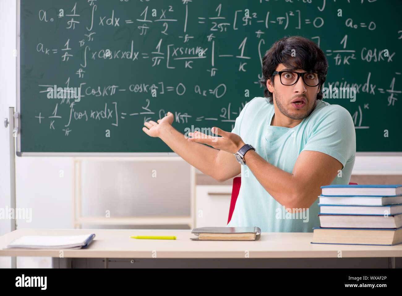 Young male student mathematician in front of chalkboard Stock Photo - Alamy