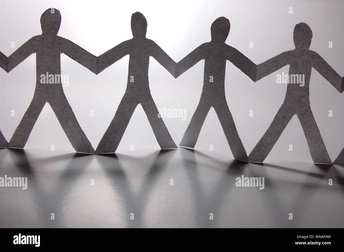 paper people doing teamwork in their business Stock Photo - Alamy