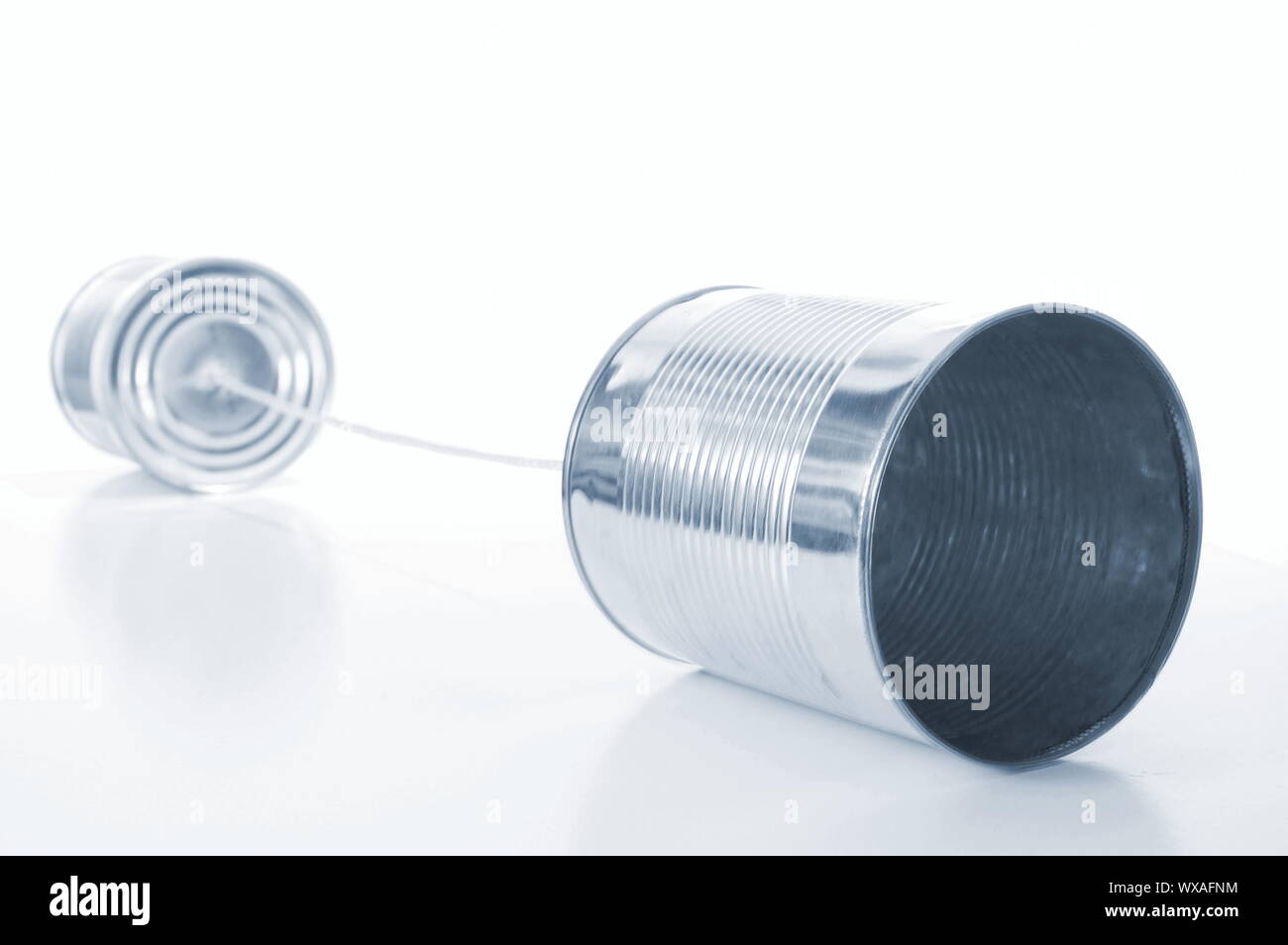 isolated tin or can telephone showing communication Stock Photo - Alamy