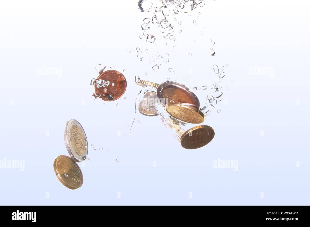 money in water with bubbles on white background Stock Photo - Alamy