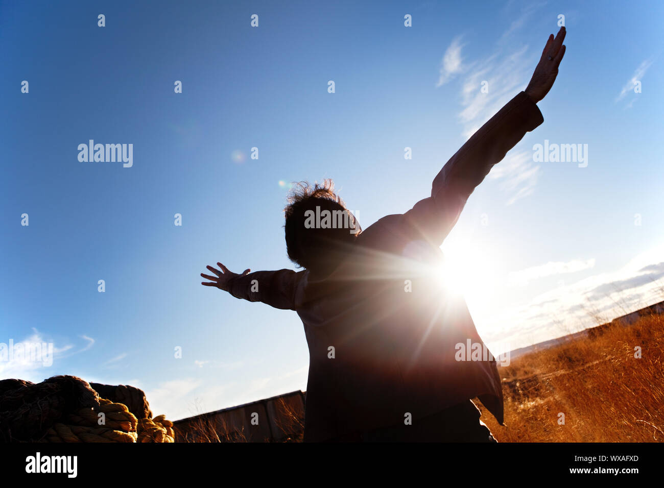 Silhouette of boy with open arms to the sky Stock Photo - Alamy