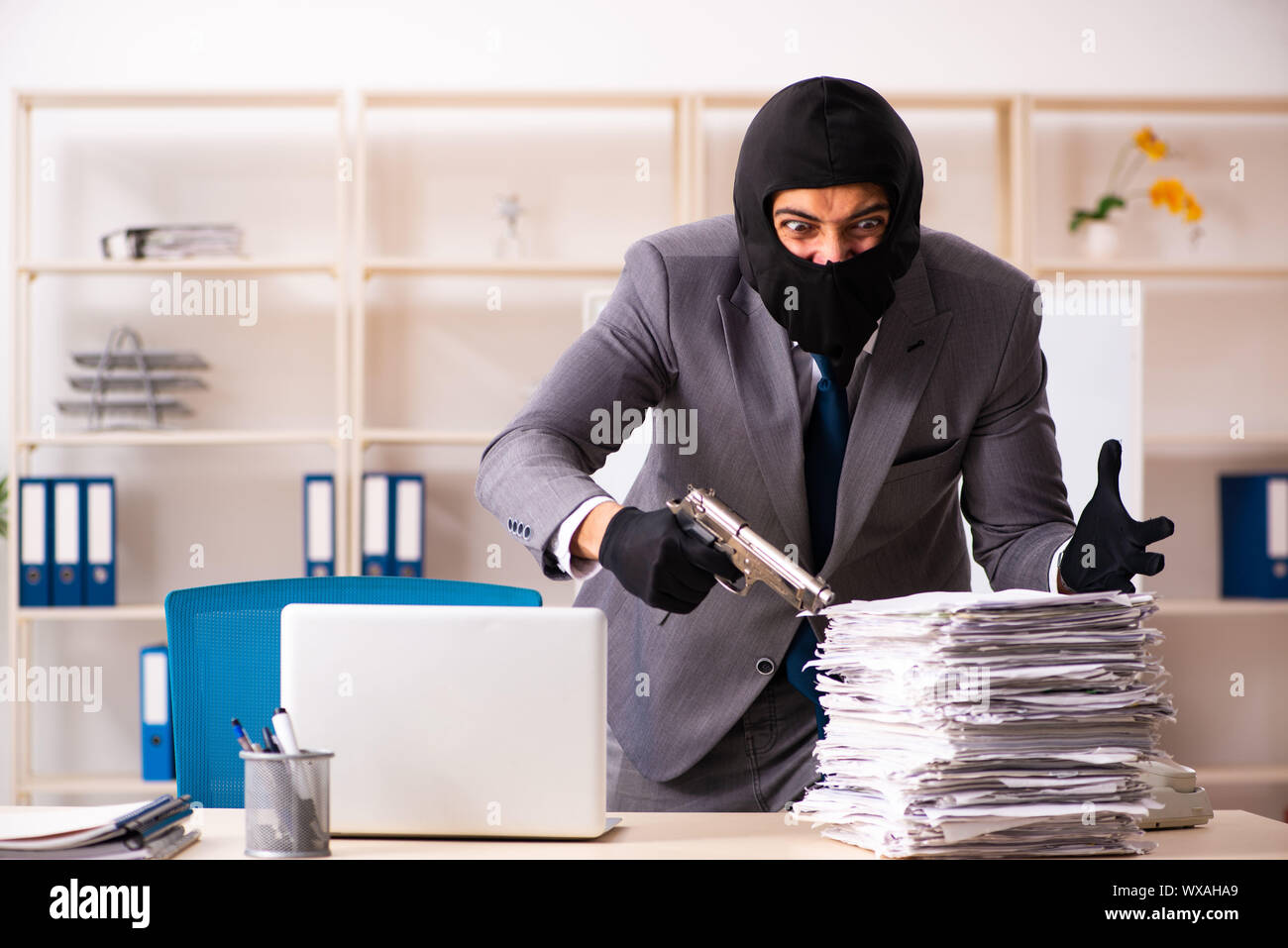 Male gangster stealing information from the office Stock Photo - Alamy