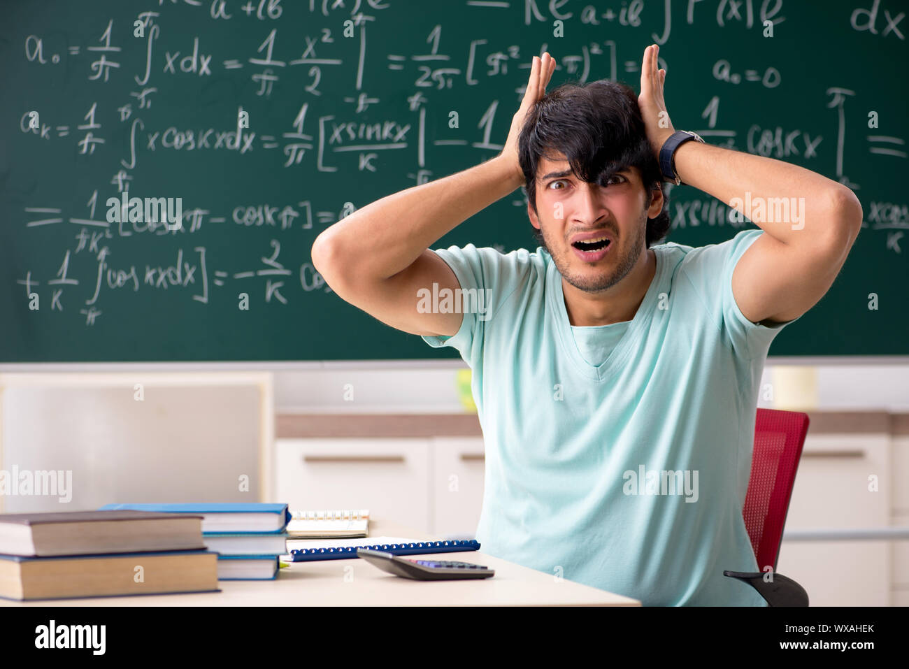 Young male student mathematician in front of chalkboard Stock Photo - Alamy