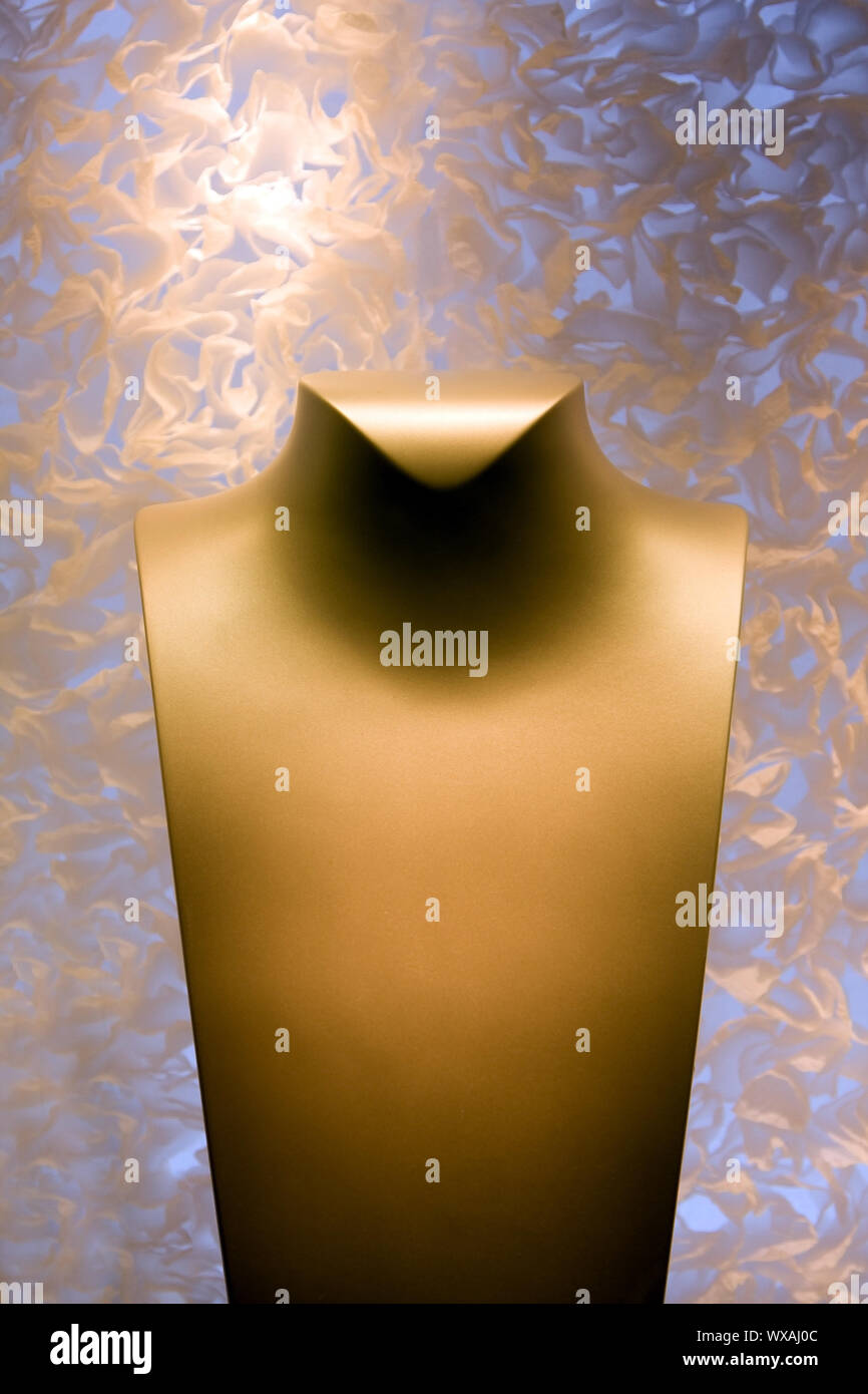 A golden yellow color neck form for display of necklace jewelry on a ...