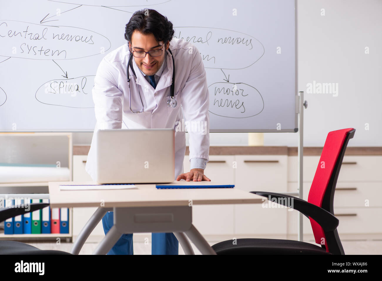 Young male doctor neurologist in front of whiteboard Stock Photo - Alamy