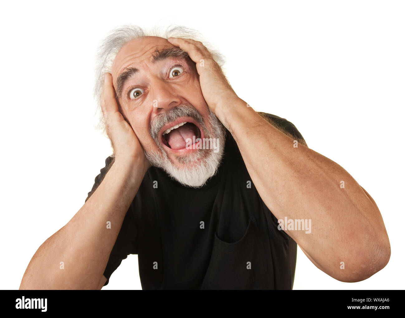 Screaming man covering his ears over white background Stock Photo - Alamy