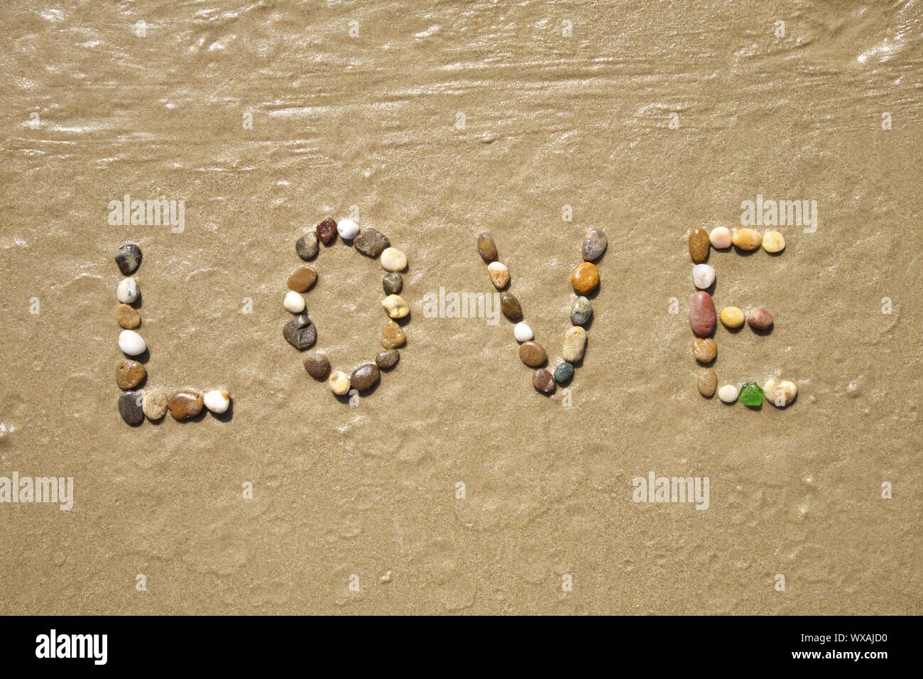 Seashore love written on sand hi-res stock photography and images - Alamy
