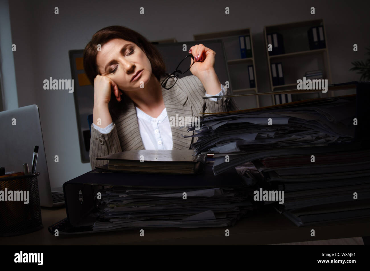Female employee suffering from excessive work Stock Photo - Alamy