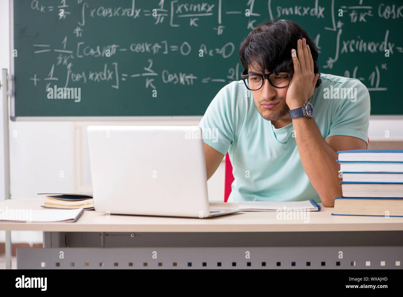 Young male student mathematician in front of chalkboard Stock Photo - Alamy