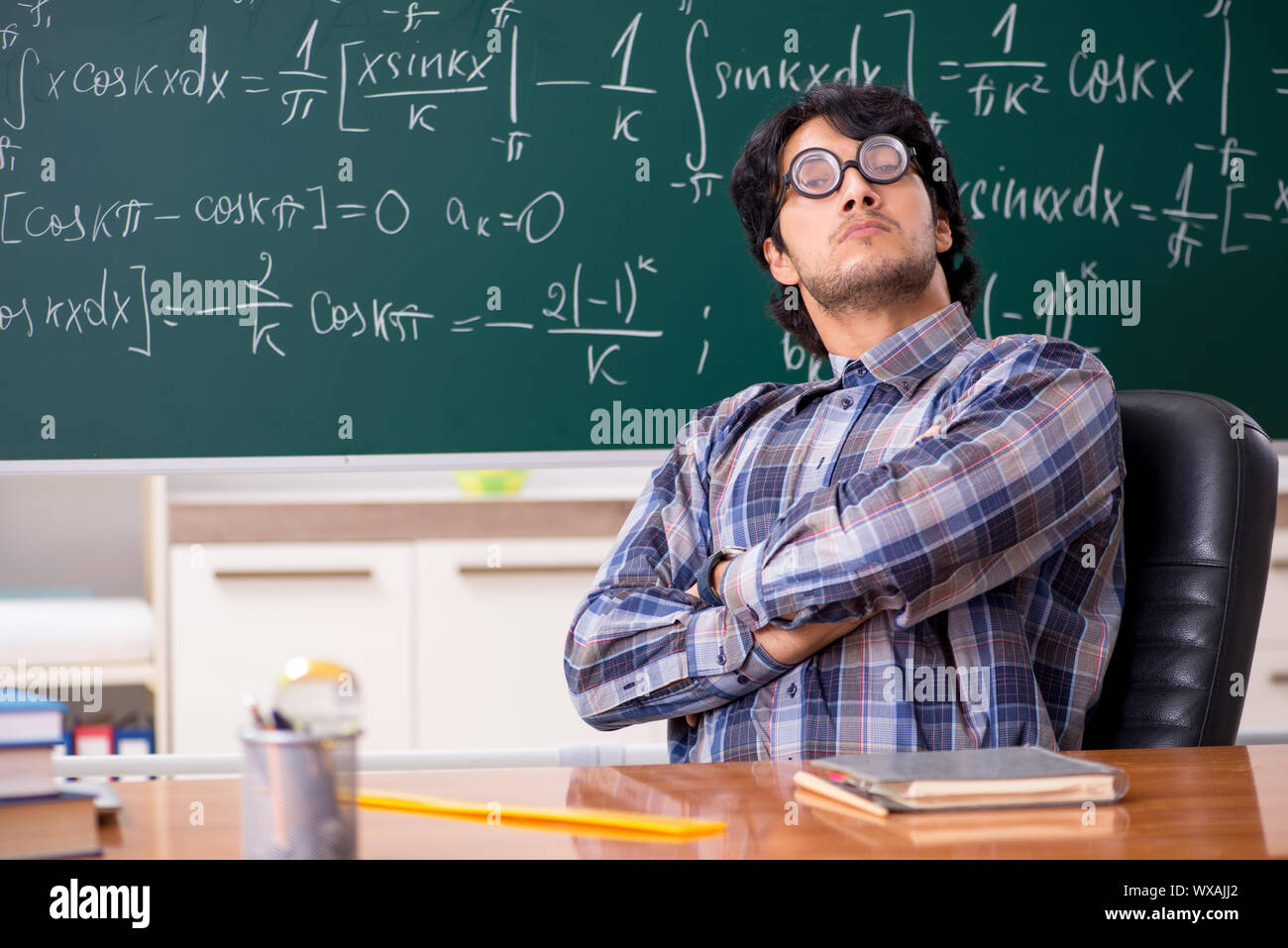 Funny male math teacher in the classroom Stock Photo - Alamy