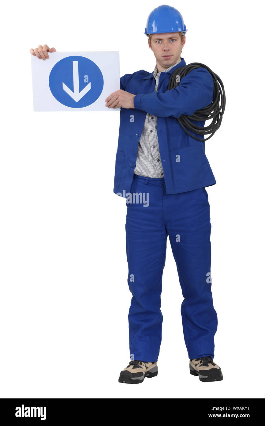 Tradesman holding a traffic sign Stock Photo - Alamy