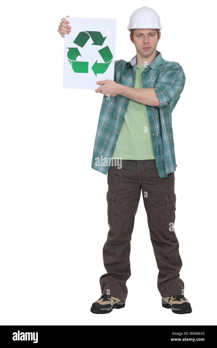 Construction worker holding a recycle sign Stock Photo - Alamy