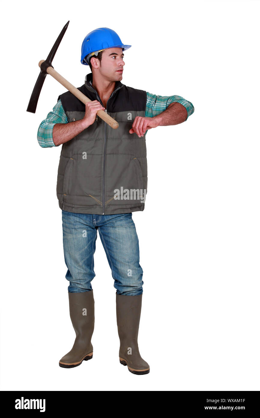 Construction worker with a pickaxe leaning on empty copyspace Stock ...