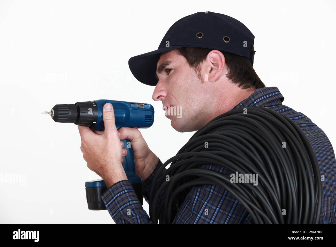 A man holding a drill Stock Photo - Alamy