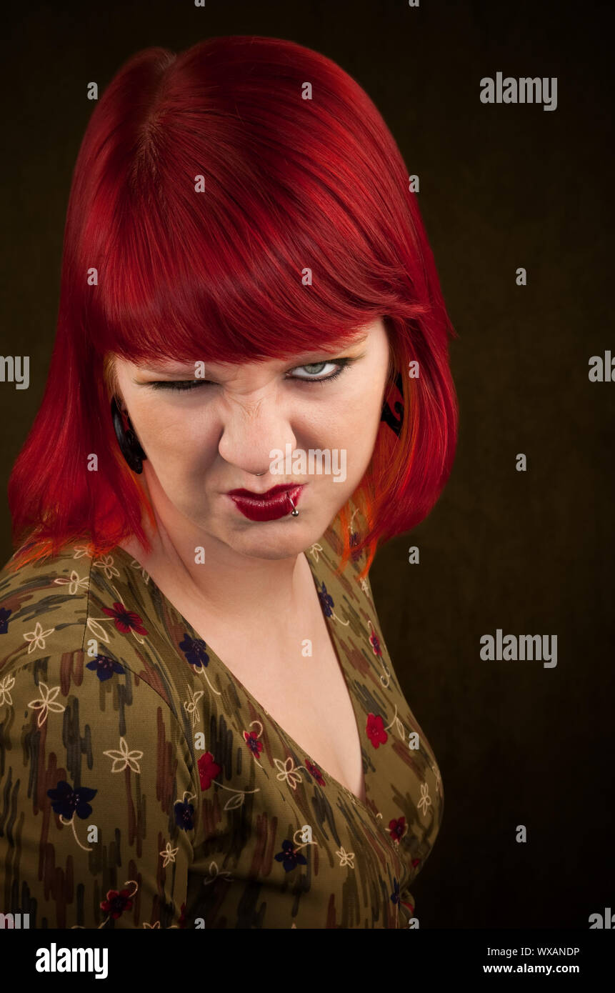 Pretty punky girl with brightly dyed red hair Stock Photo - Alamy