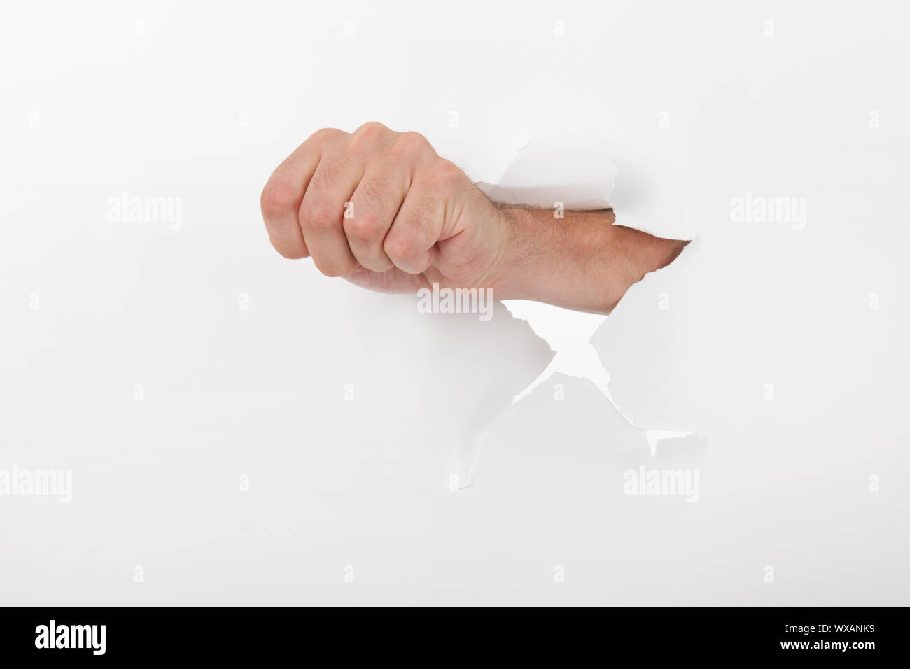 Human fist through the broken wall Stock Photo - Alamy