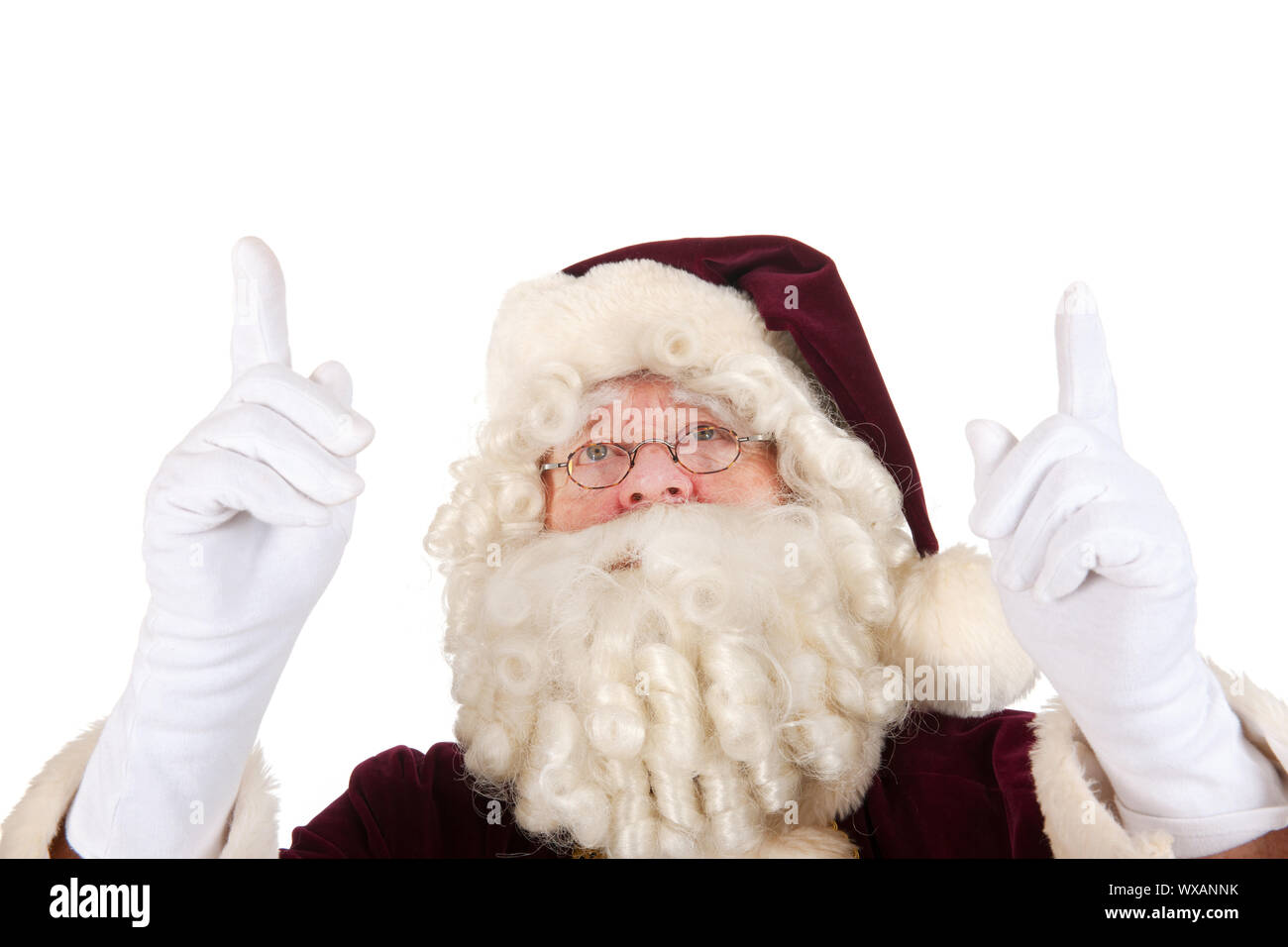 Santa Claus is pointing upwards to something isolated over white ...