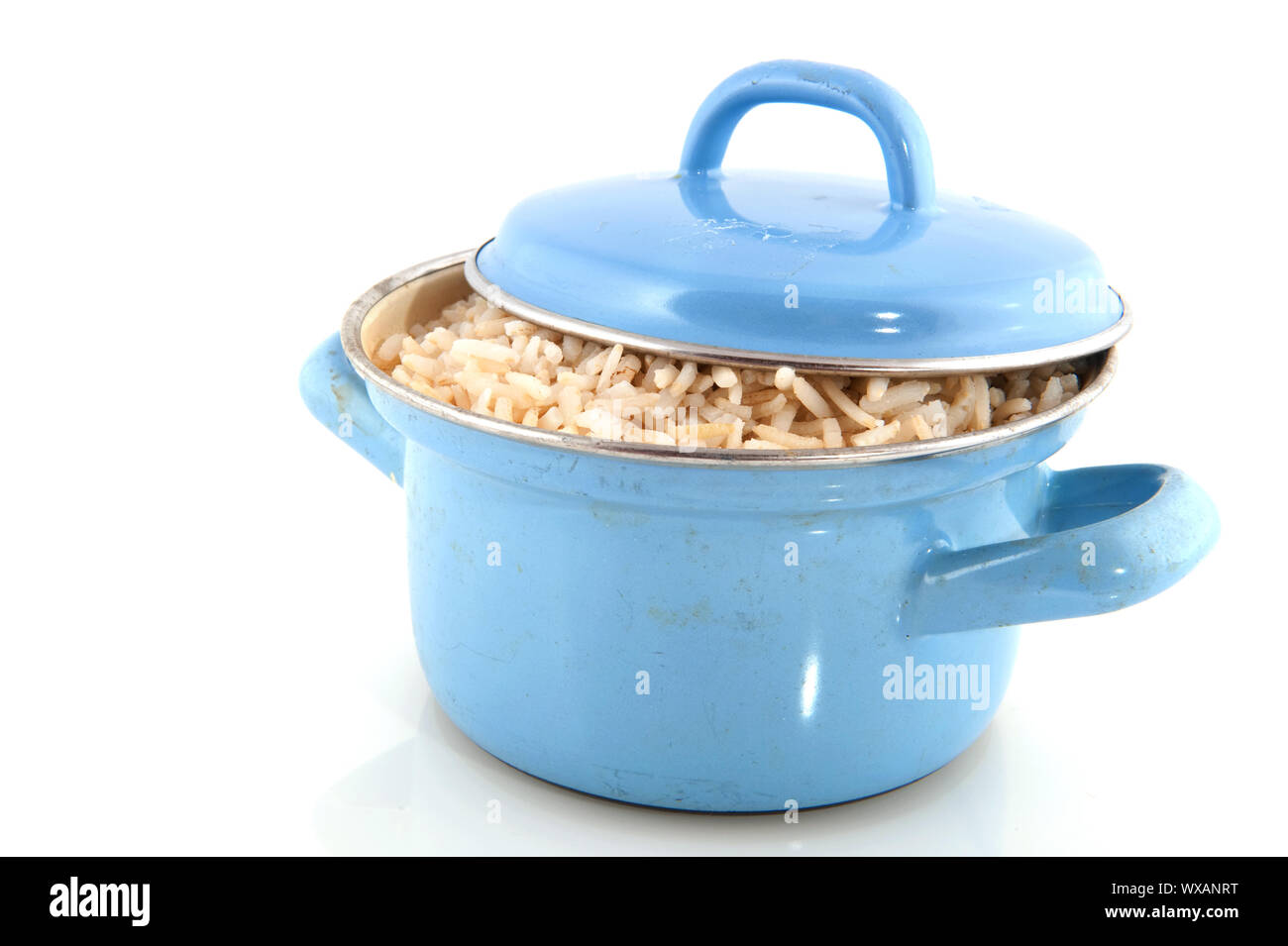 cooking brown rice in blue used pan Stock Photo - Alamy