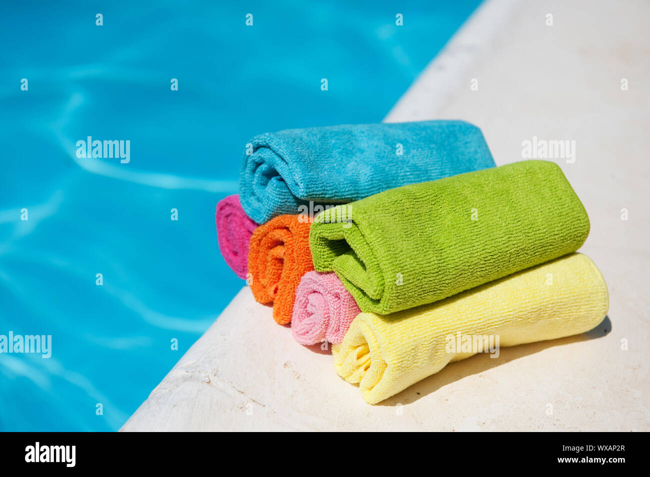 colorful rolled towels near the swimming pool Stock Photo - Alamy