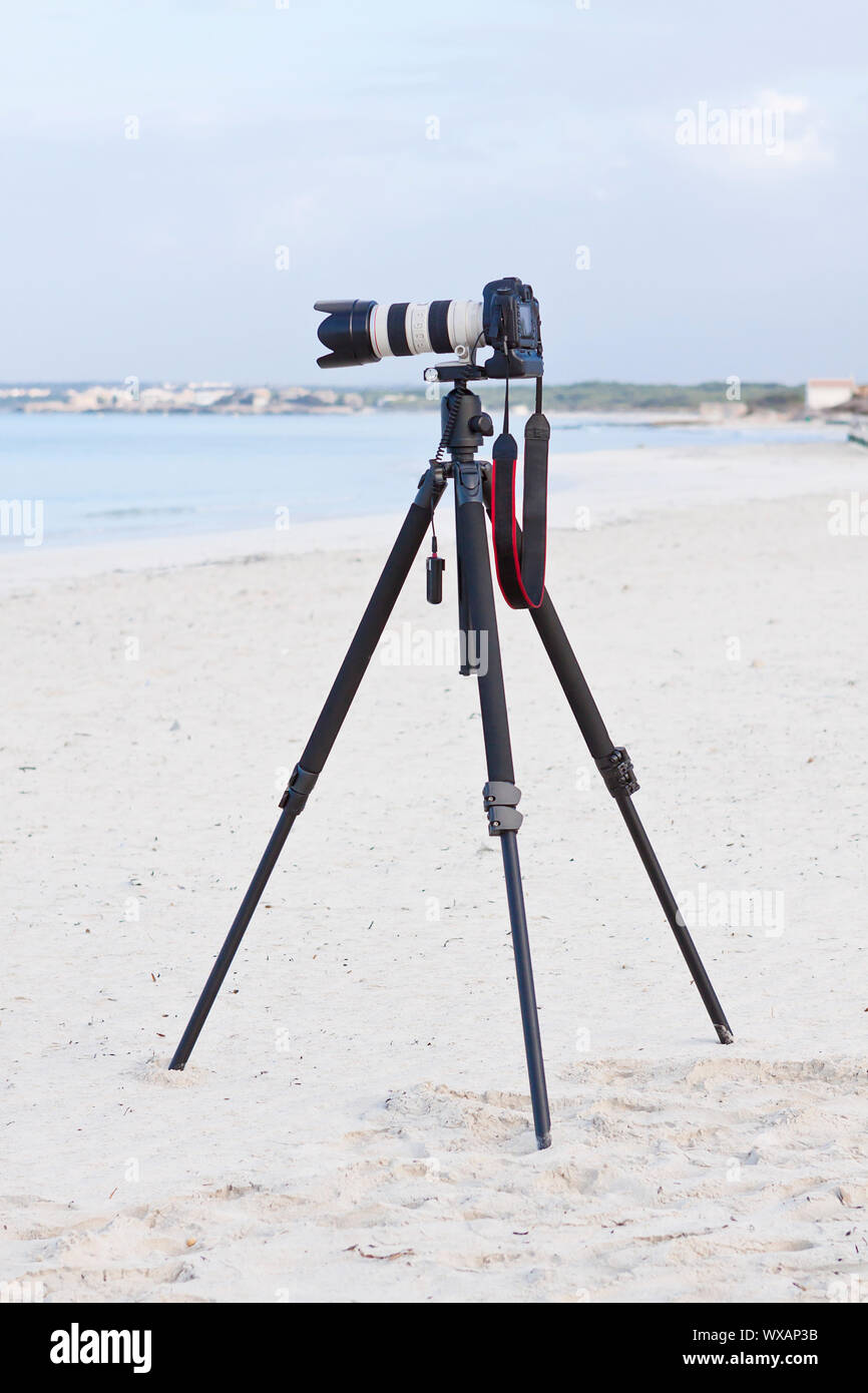 digital slr camera on tripod on beach in summer outdoor Stock Photo - Alamy