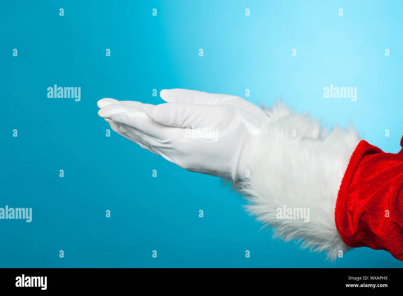 Copy space concept. Open palms of Santa. Blue background Stock Photo ...
