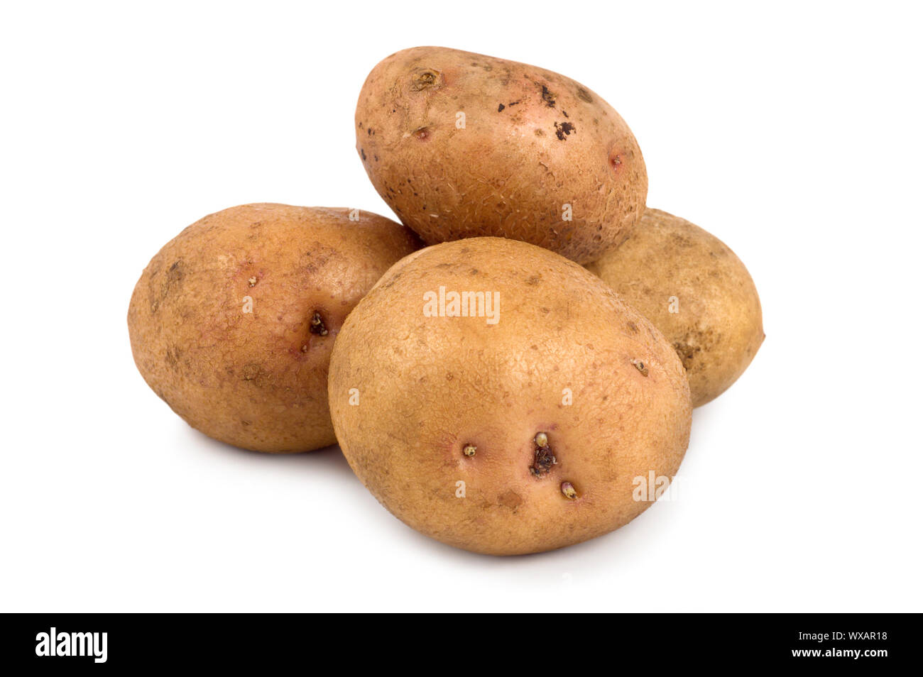 Three potatoes isolated on a white background Stock Photo - Alamy