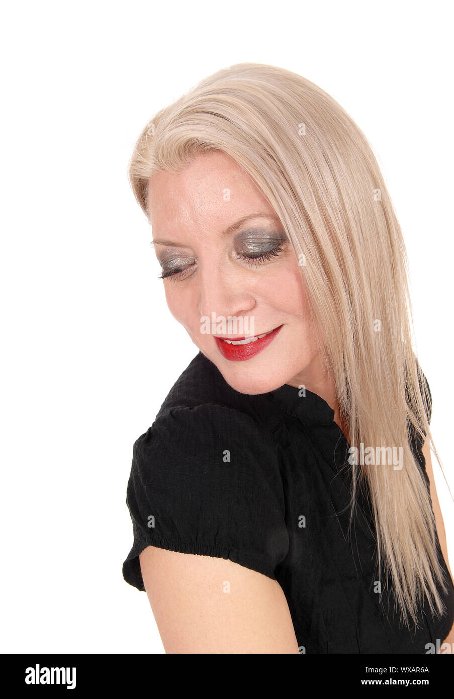 Woman looking down smiling with her long blond hair Stock Photo - Alamy