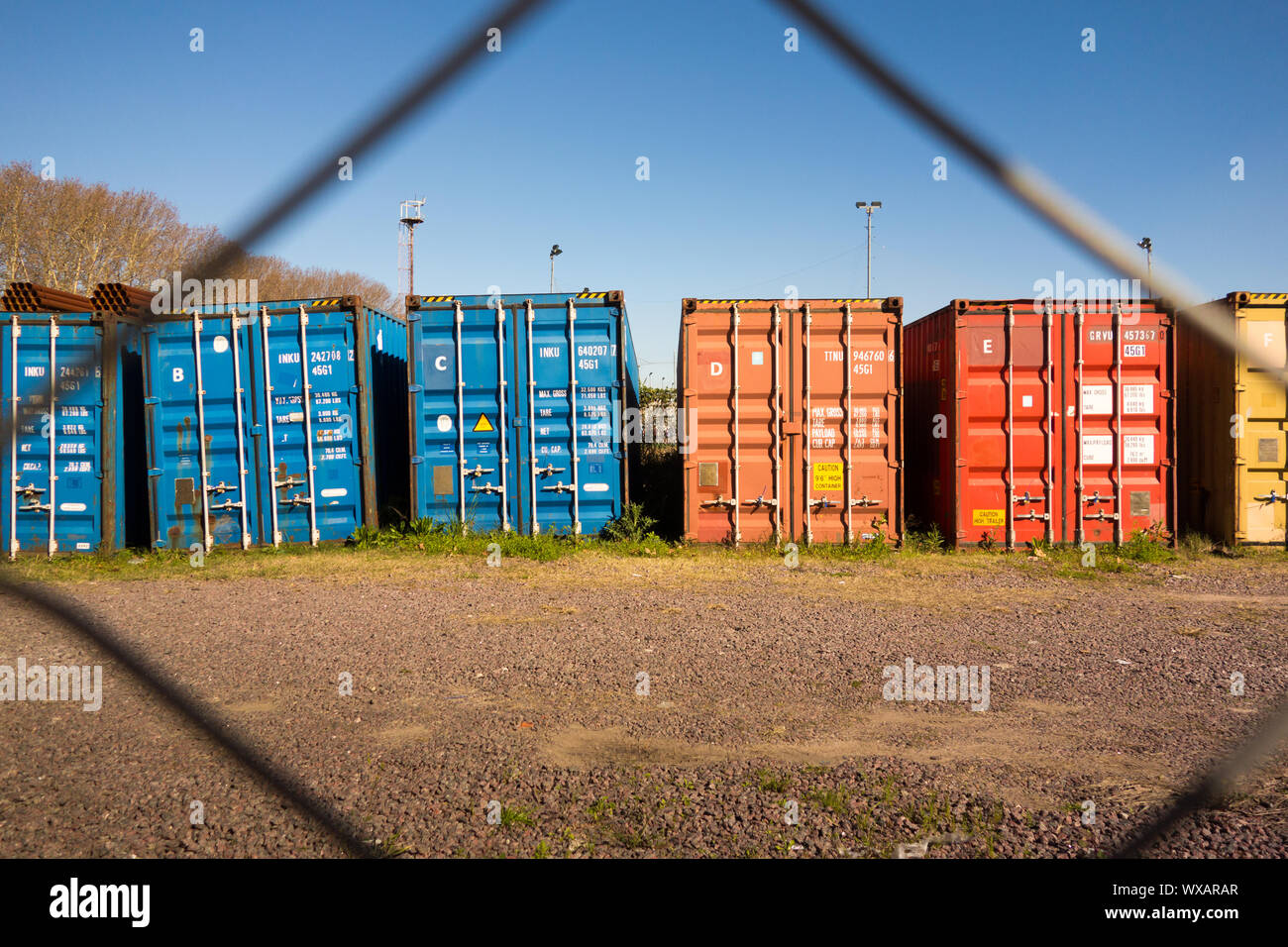 Cargo containers behind fence hi-res stock photography and images - Alamy