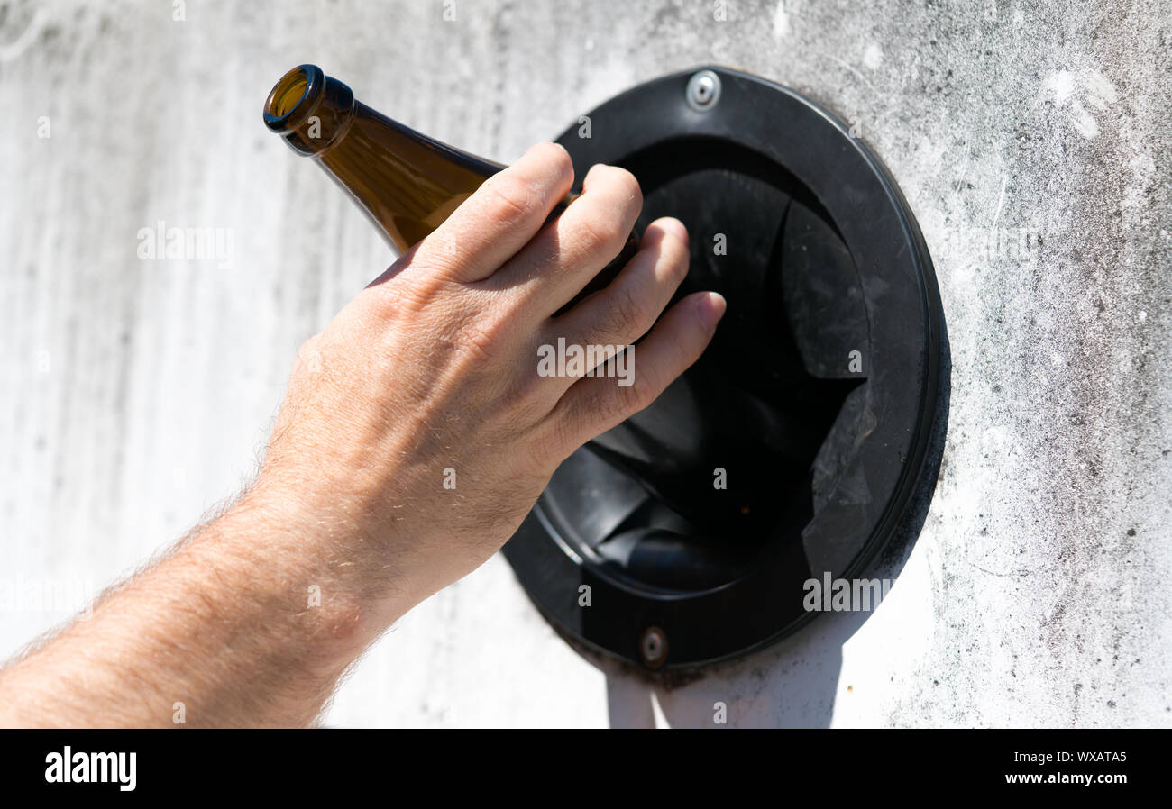 environmentally friendly man uses city facilities to recycle glass ...