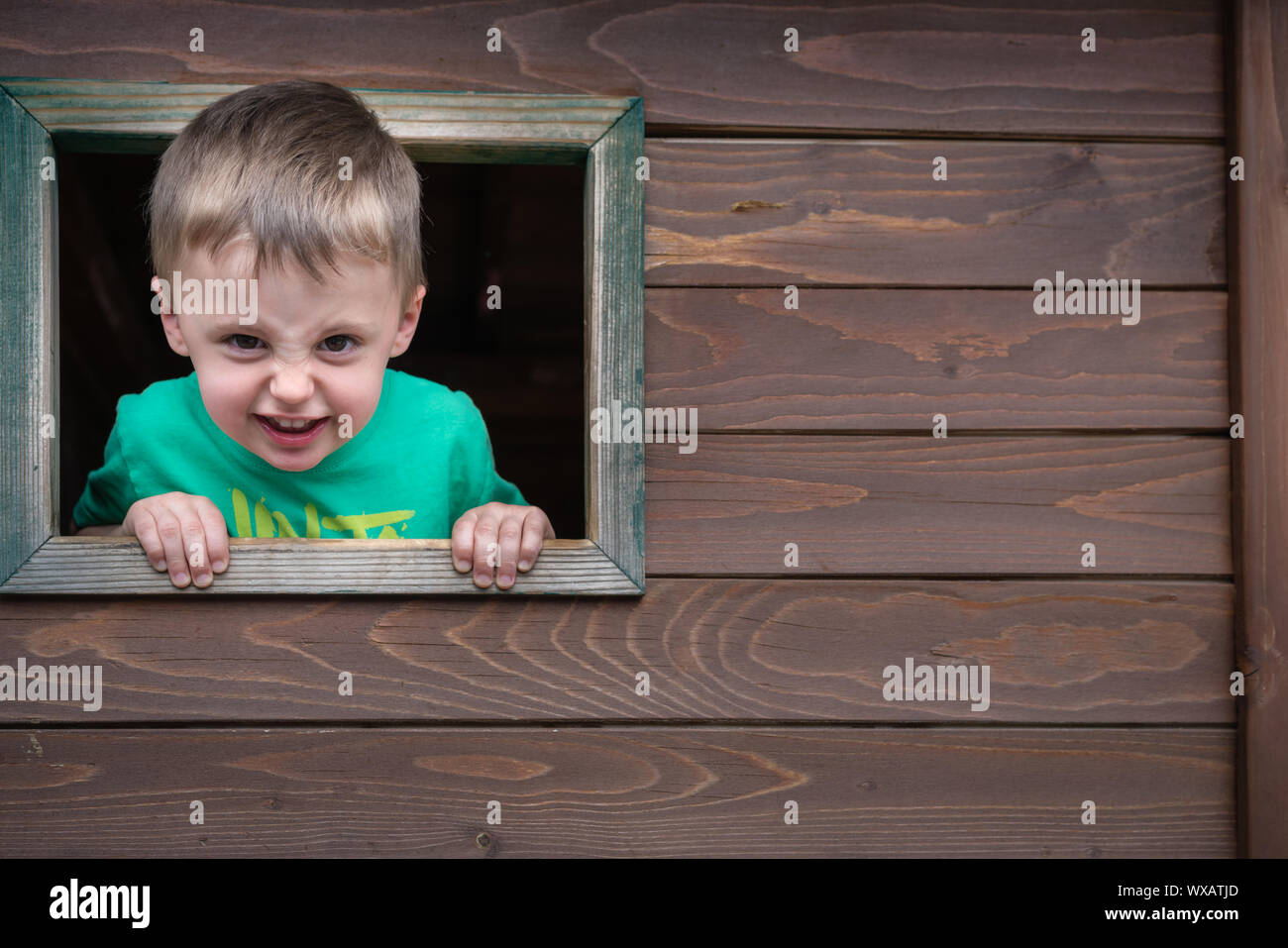 Boy peeking through window hi-res stock photography and images - Alamy