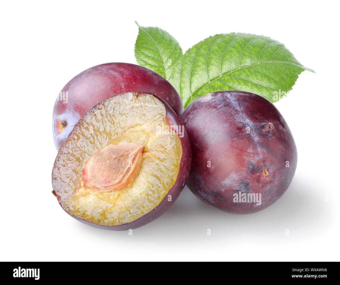 Three plums with leaves isolated on a white background Stock Photo - Alamy
