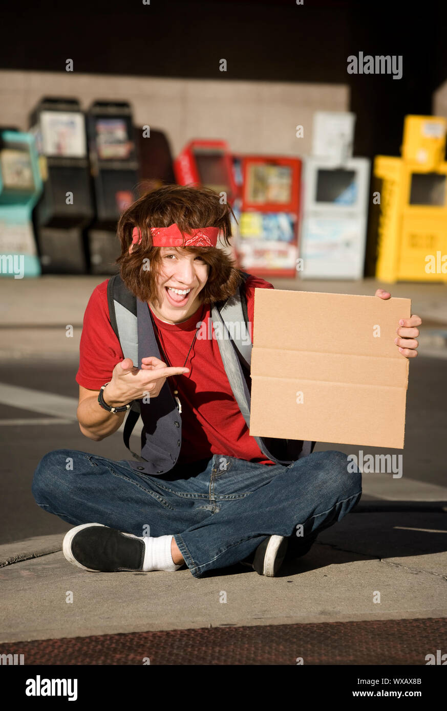 Young Man on Street Corner with Blank Cardboard Sign Stock Photo - Alamy