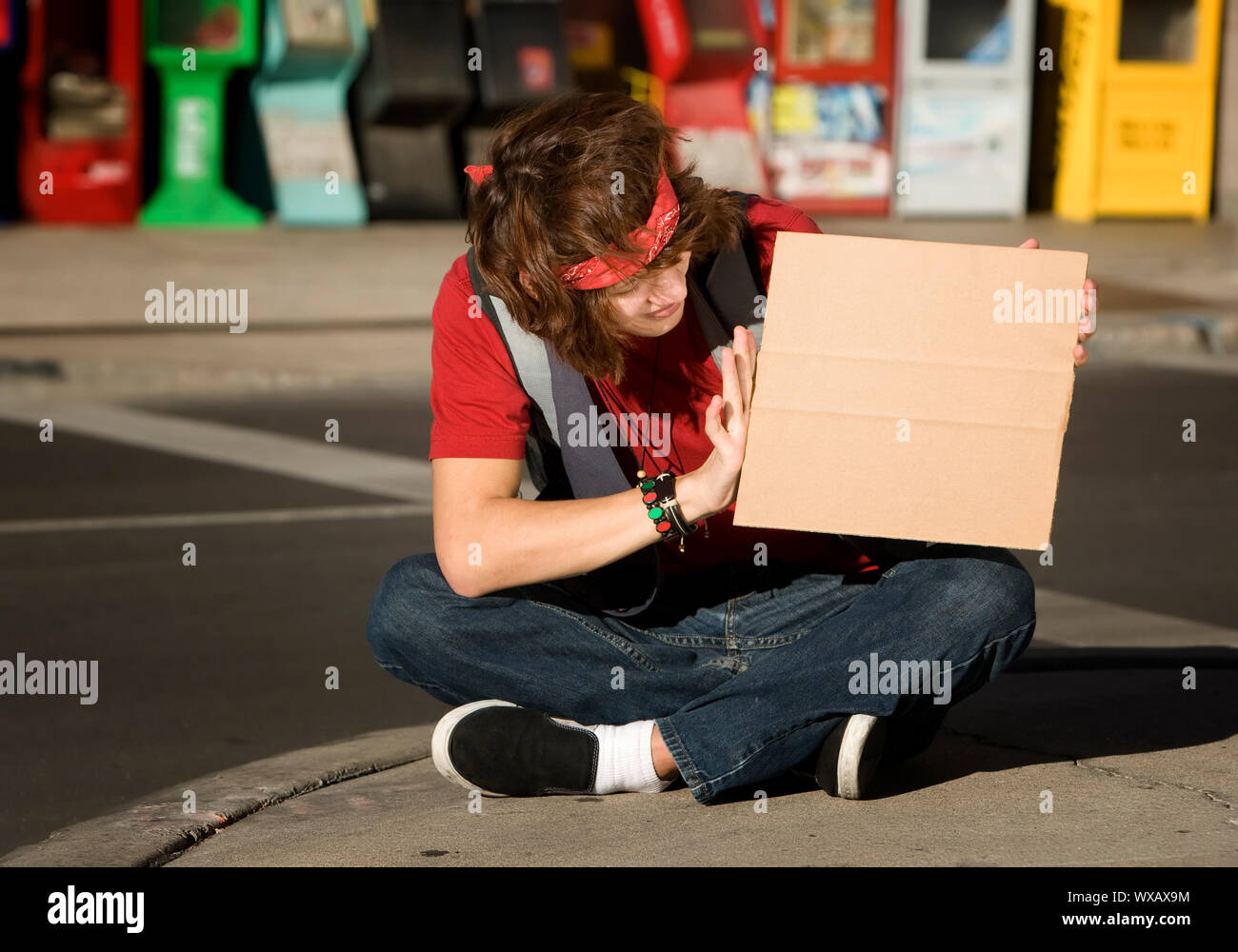 Young Man on Street Corner with Blank Cardboard Sign Stock Photo - Alamy