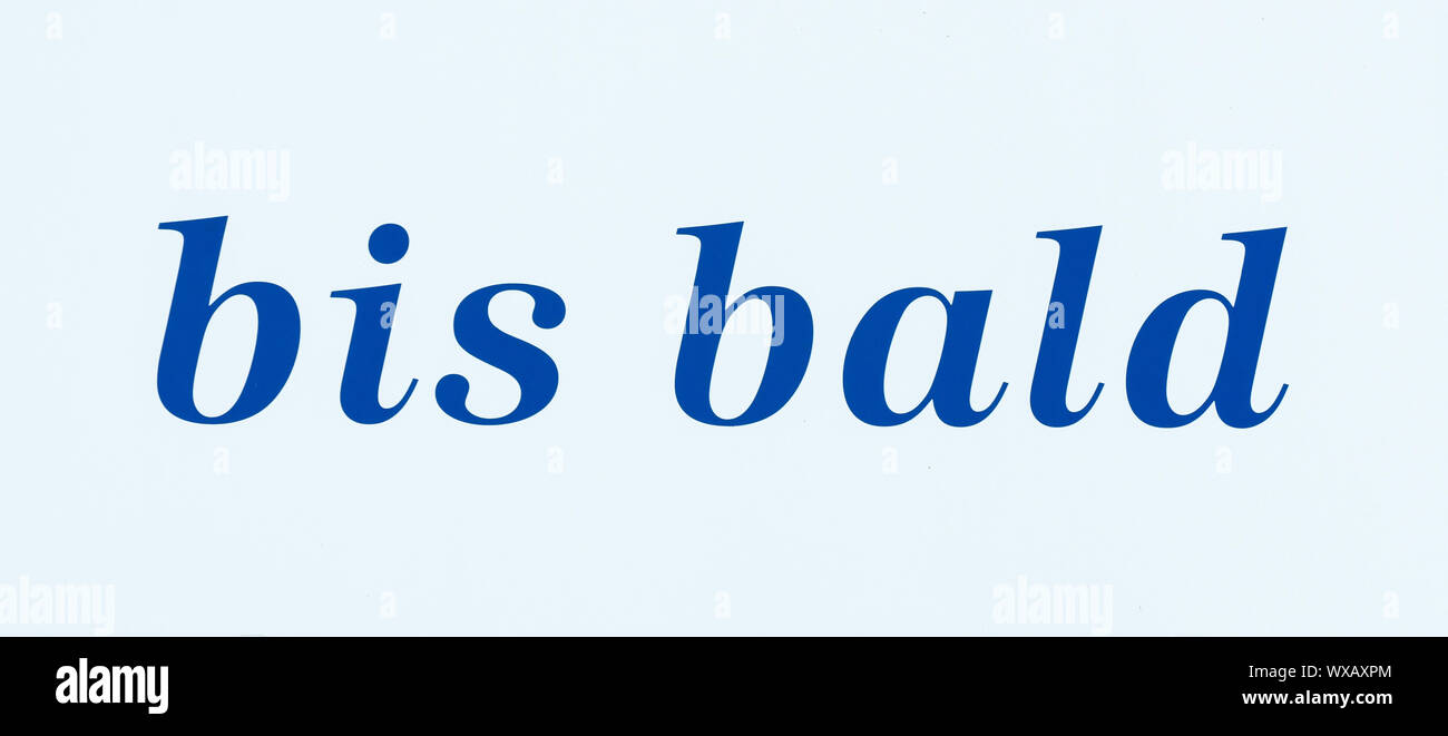 Blue Writing On White Sign Saying See You Soon In German Stock Photo Blue Writing On White Sign Saying See You Soon In German Stock Photo