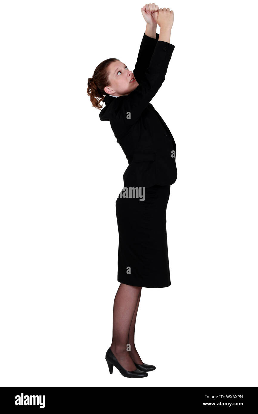 Businesswoman reaching upwards Stock Photo - Alamy