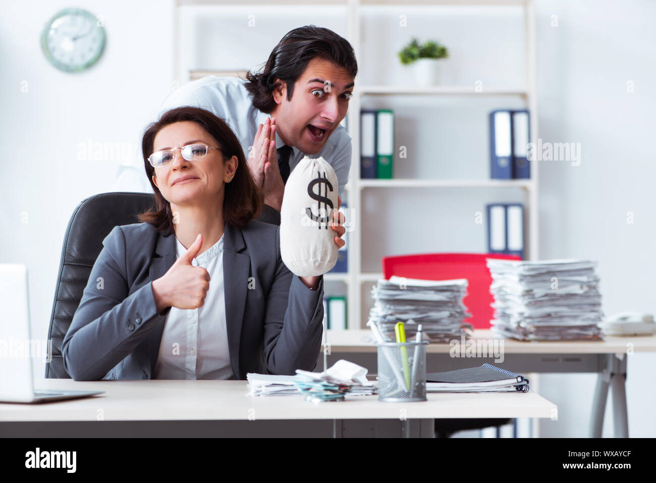 Old female boss and young male employee in the office Stock Photo - Alamy