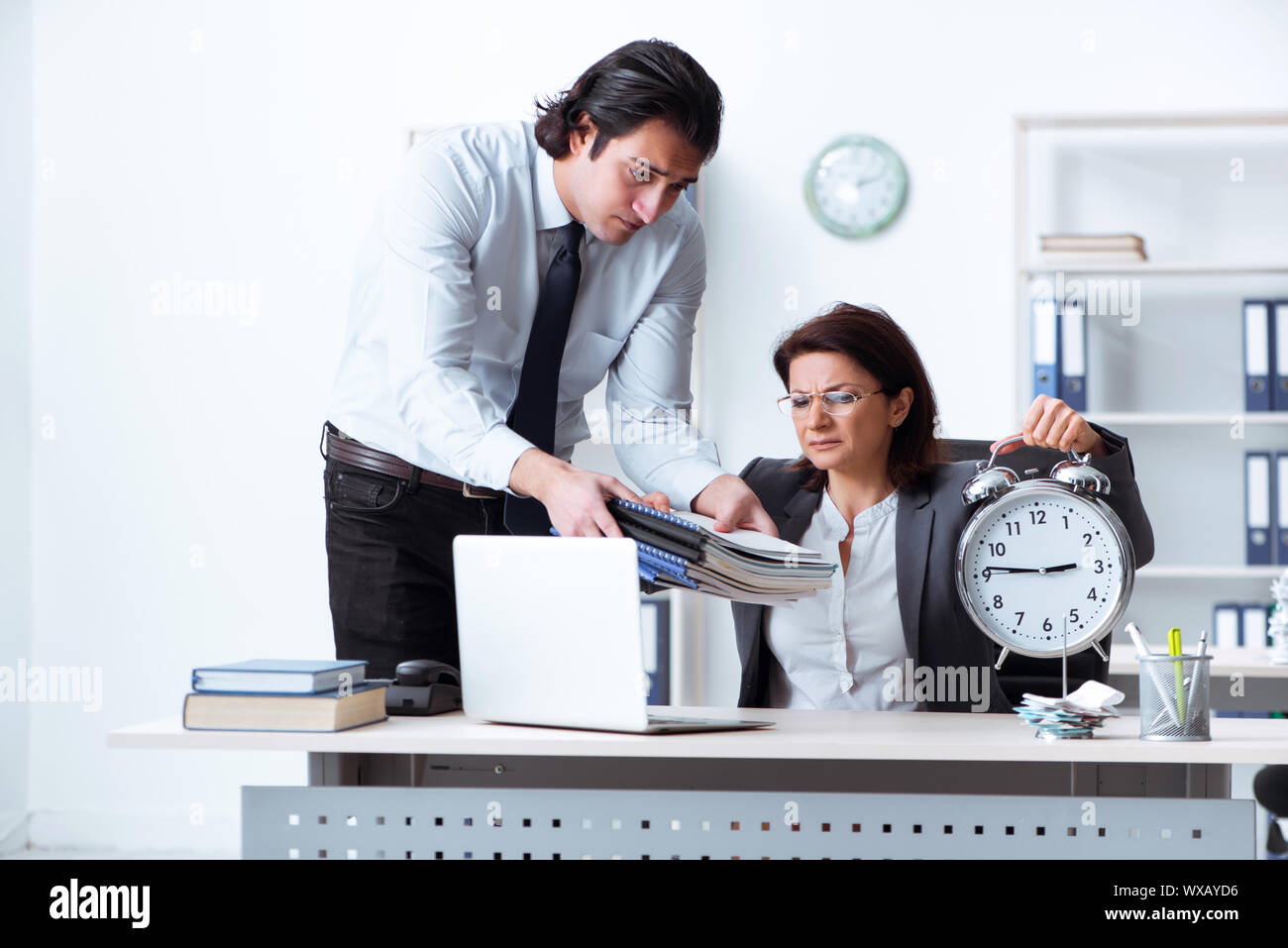 Old female boss and young male employee in the office Stock Photo - Alamy