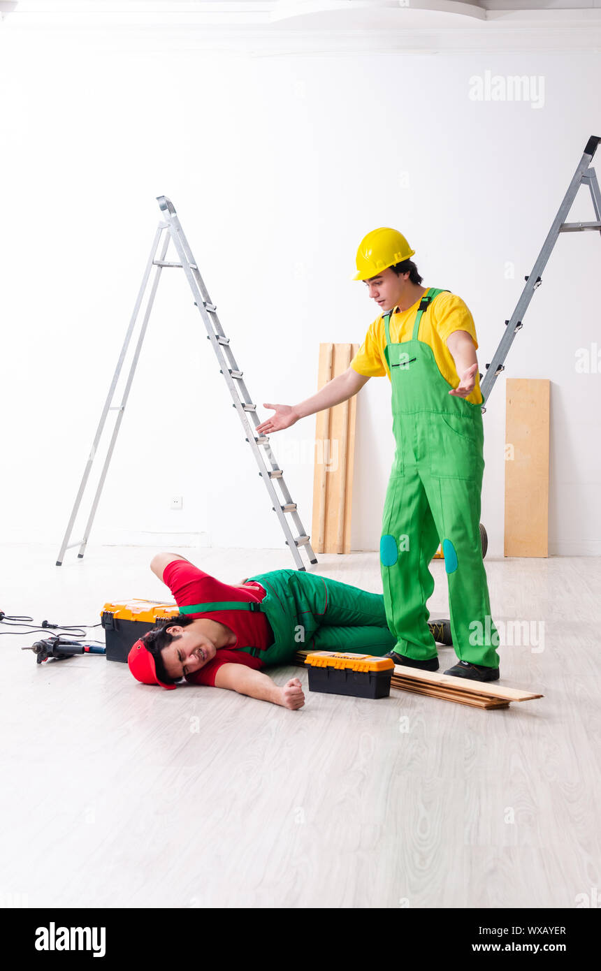 Injured worker and his workmate Stock Photo - Alamy