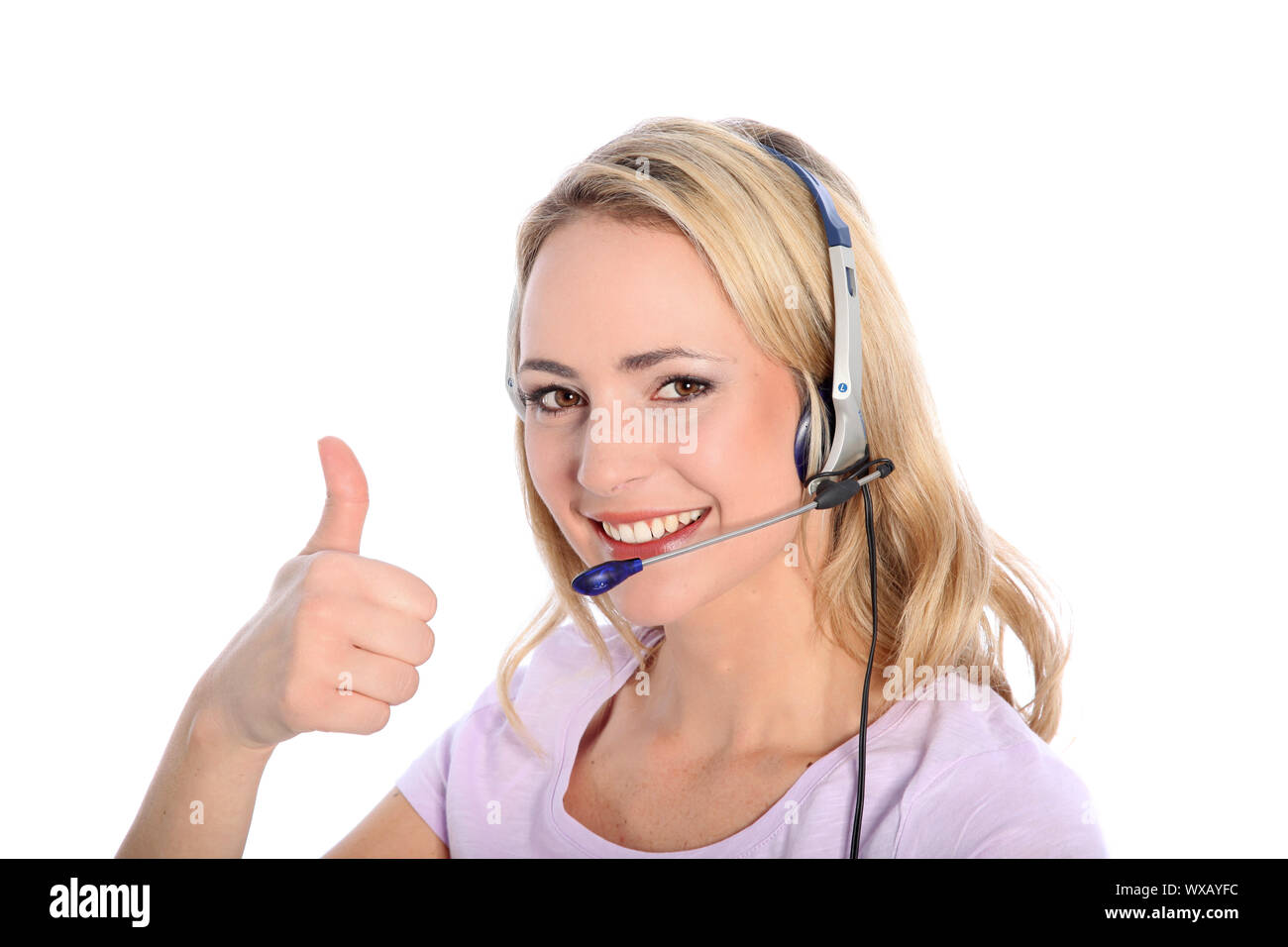 Happy young operator at a call centre or receptionist wearing a headset ...