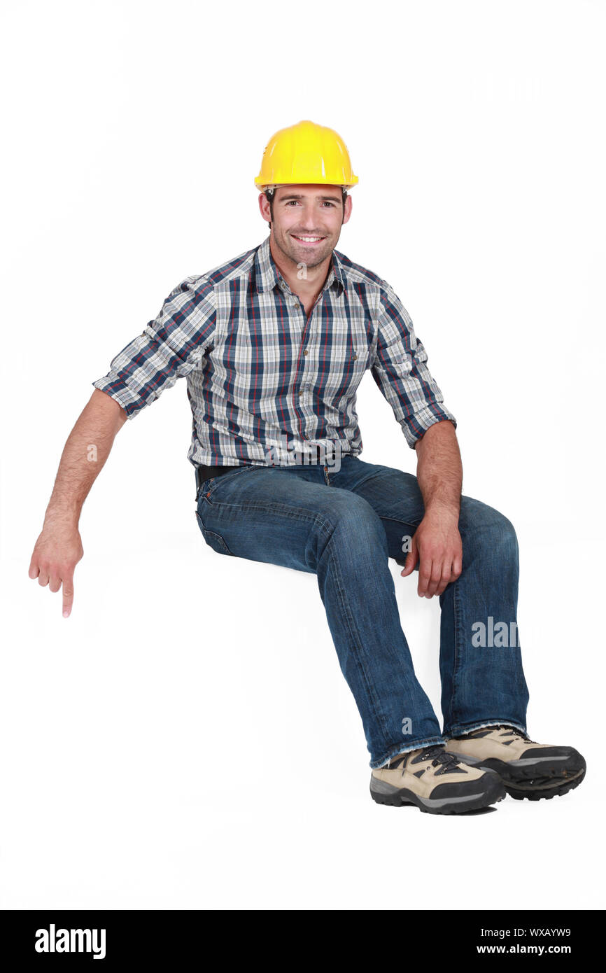 Handyman pointing downwards Stock Photo - Alamy