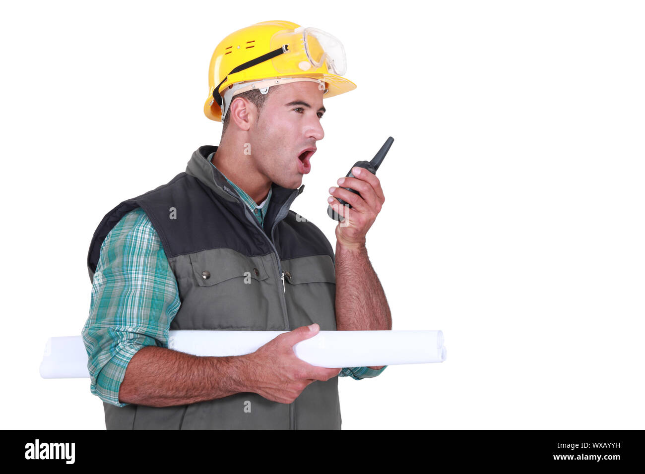 Tradesman yelling into a walkie-talkie Stock Photo - Alamy