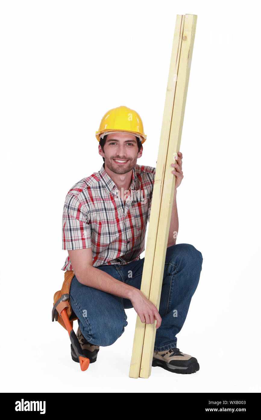 Carpenter posing with timber Stock Photo - Alamy