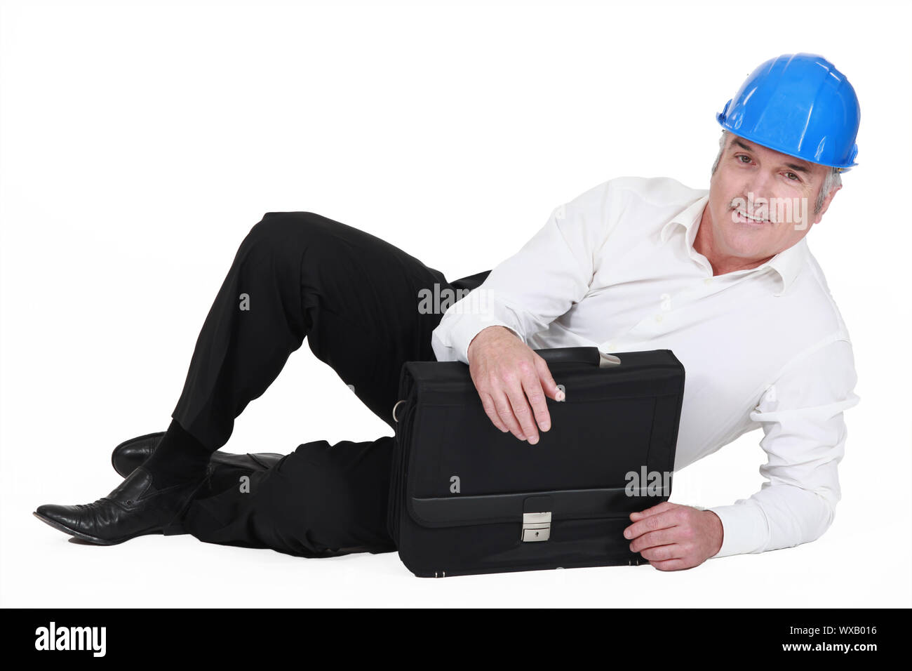 senior architect lying on floor with briefcase Stock Photo - Alamy